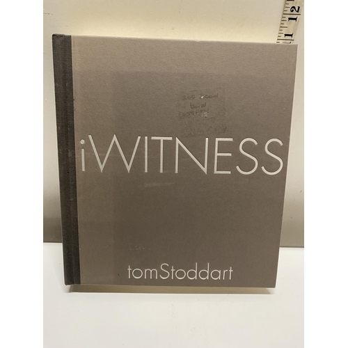 A signed hardback edition of Iwitness by Tom Stoddart