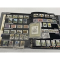 A stamp album with contents of British stock stamps