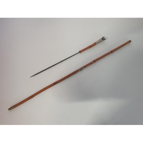 A antique cane swagger stick with a pull out blade. with brass mounts ...