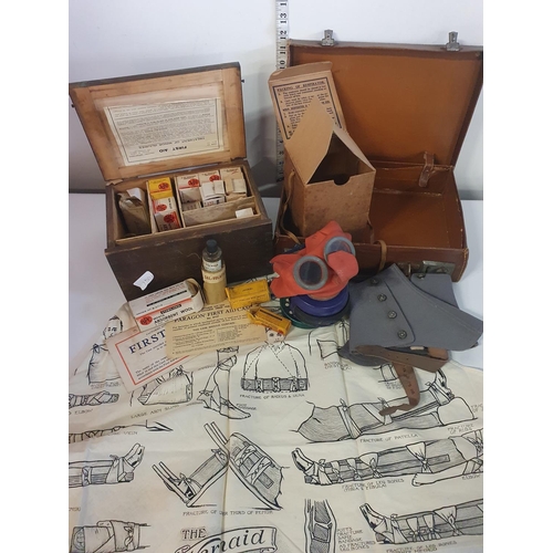 A vintage WW1 period first aid kit, suitcase and child's gas mask ...