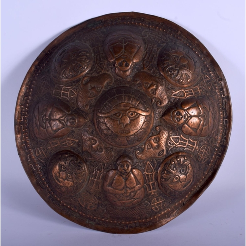 AN UNUSUAL 19TH CENTURY INDIAN TIBETAN COPPER SHIELD decorated with ...