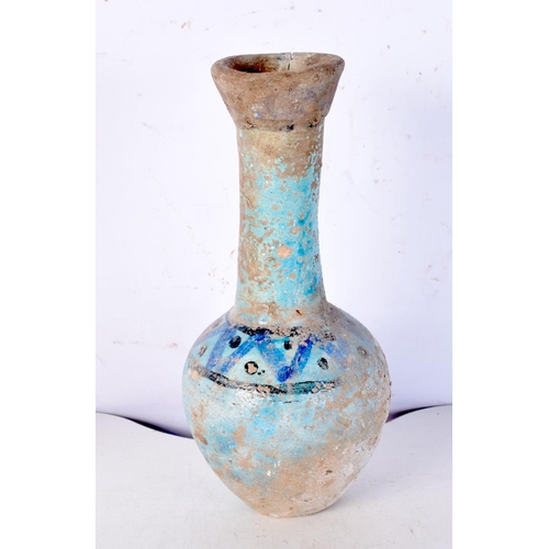 An Islamic blue glazed pottery vase. 24 cm.