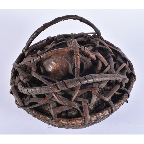 AN UNUSUAL AFRICAN TRIBAL CARVED WICKER BAMBOO SKULL BASKET. 21 cm wide.