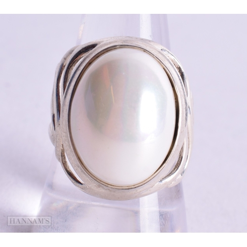 A SILVER RING WITH A PEARLESCENT STONE. Stamped 925, Size Q, weight 8.9g