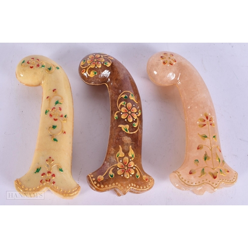 THREE MIDDLE EASTERN LACQUERED STONE DAGGER HANDLES. 16 cm long. (3)