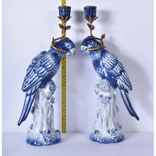 A pair of blue porcelain parrot candlesticks 36cm (2)