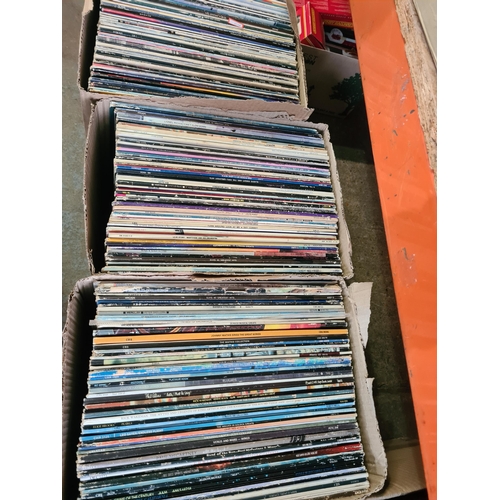 Three boxes of vinyl LP records, mixed genres and decades