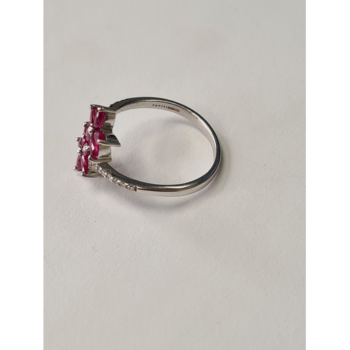 18ct white dress ring with two ruby inset flower heads of cross over ...