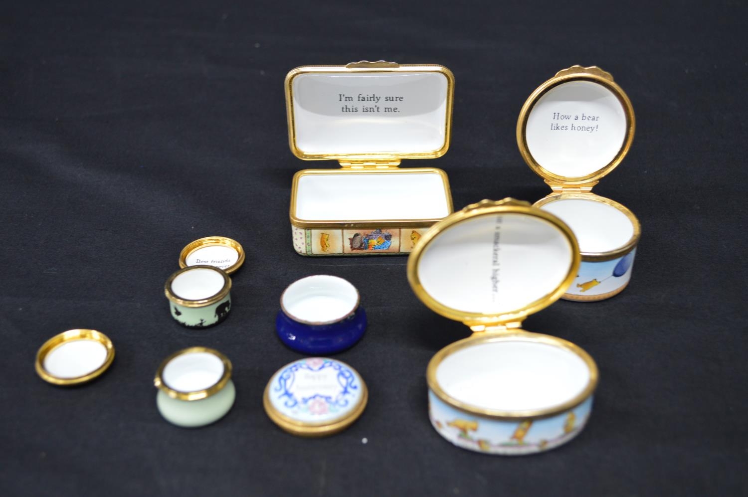 Group of five Halcyon Days enamel trinket boxes (four Winnie the Pooh ...