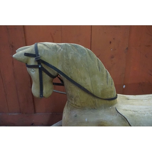 An antique Folk Art style rocking horse, 150cm long.