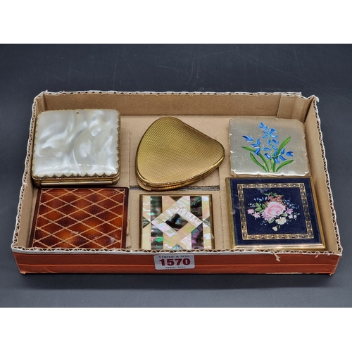 Six compacts, to include a Stratton example.