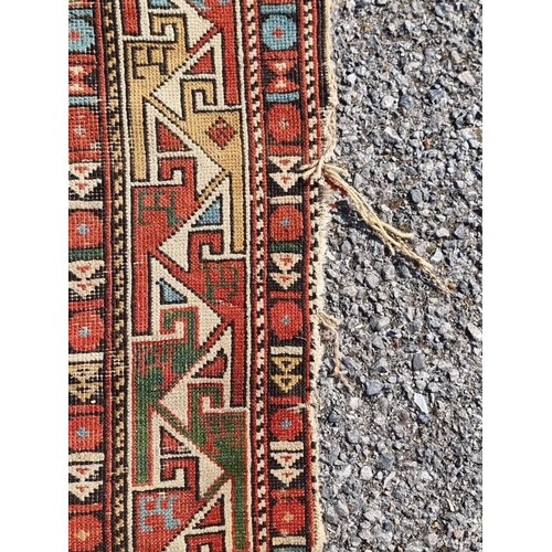 A Caucasian rug, having geometric borders, 152 x 123cm.