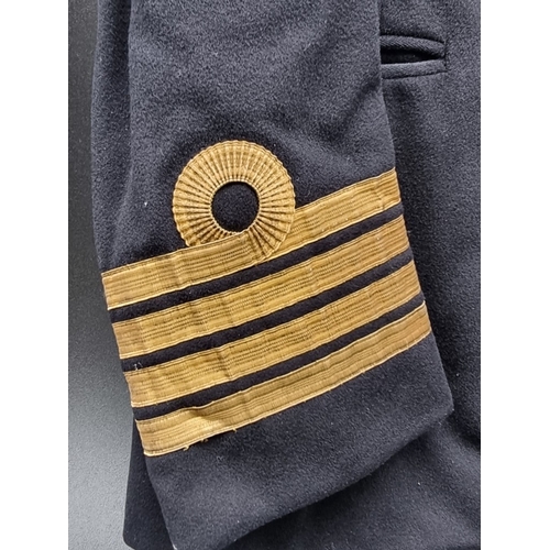 A Royal Navy captain's jacket and cap. (2)