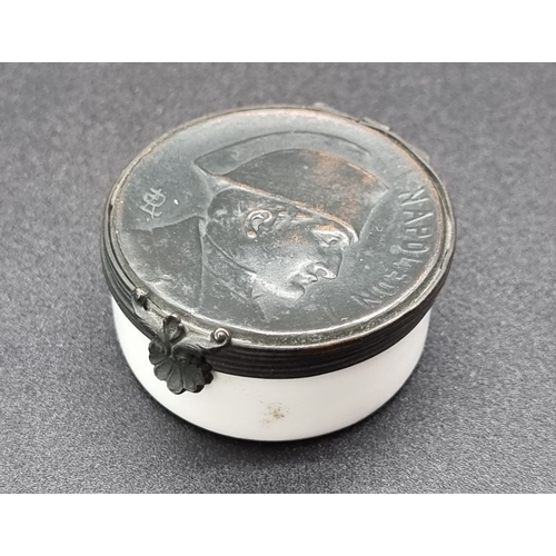 An opaque glass and patinated metal 'Napoleon' pill box, 4.8cm diameter.