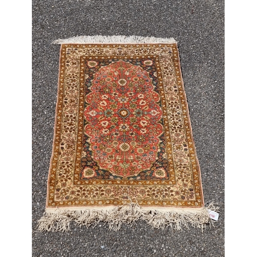 A small Persian silk rug, having allover floral decoration, 126 x 74cm.
