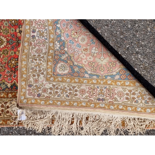 A small Persian silk rug, having allover floral decoration, 126 x 74cm.