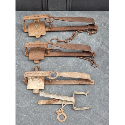 Four antique animal traps.