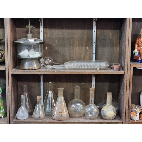 A collection of science laboratory glass bottles and related.