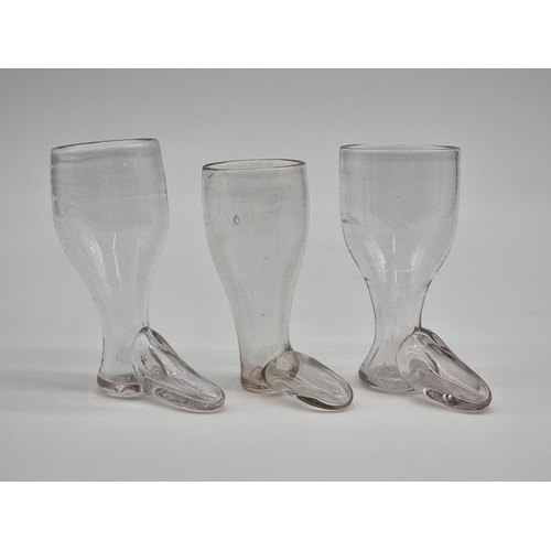 Three similar novelty stirrup cups, largest 9.5cm high.