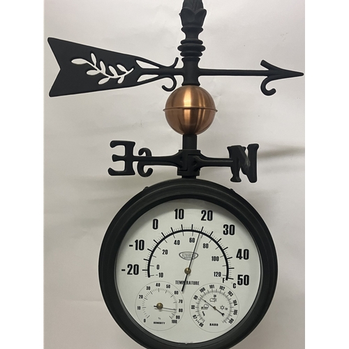 Modern clock barometer and weather vein on metal stand.