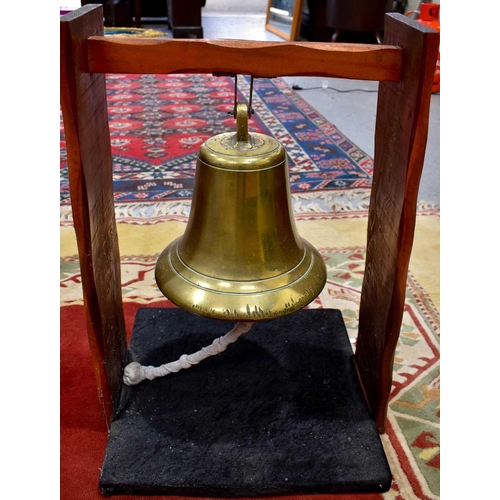 A large antique brass ships bell raised on a later stand, the bell ...
