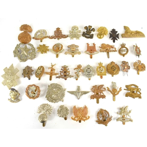 A group of Victorian and later military cap badges to include Royal ...
