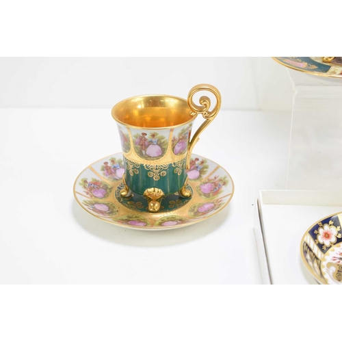 A set of four Vienna porcelain coffee cans and saucers, a pair of ...