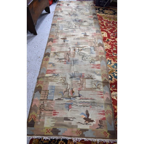 A Turkish wool kelim rug, with abstracted geometric motifs in pastel ...