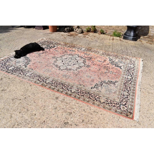Two similar wool and silk blend rugs profusely decorated with stylised ...