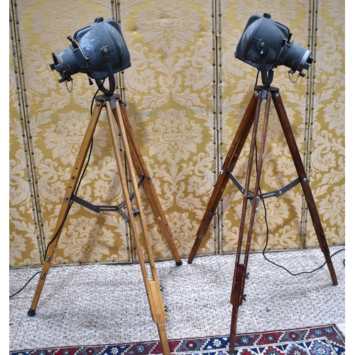 A pair of vintage Strand theatre lights on tripod stands.