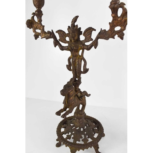 A near pair of late 19th century Indonesian bronze figural candelabra ...