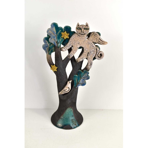 A studio pottery cat with wings in tree, unsigned, 32cm high.