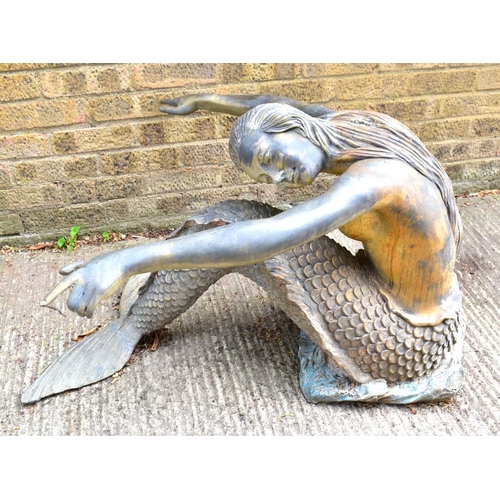 A bronzed metal mermaid, 55 by 80cm.