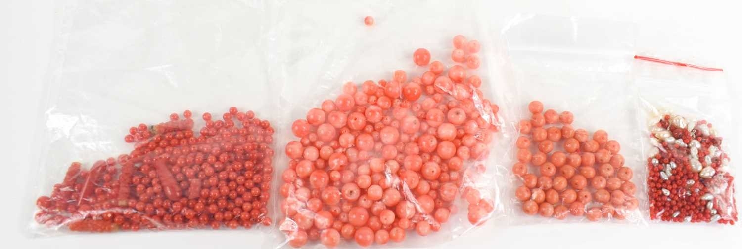 A selection of various loose coral beads from necklaces; one in dark ...