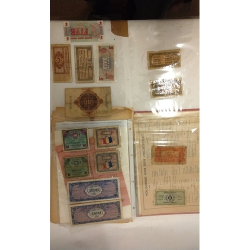 A folder containing foreign paper currency and war memorabilia