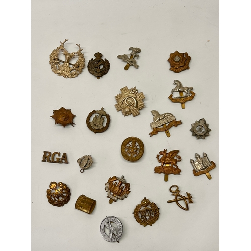 Collection Of Various Metal Military Cap Badges.