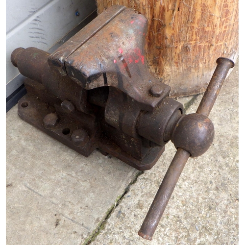 An anvil on a tree stump log together with a vice (2)
