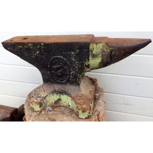 An anvil on a tree stump log together with a vice (2)