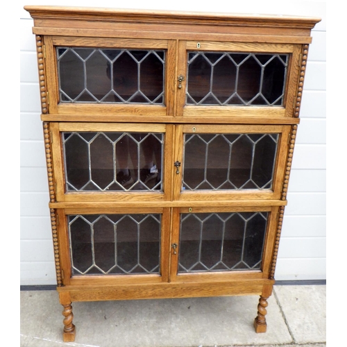 A Simpoles three section stacking bookcase with leaded glass doors ...