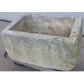 A rectangular stone trough 77 x 50 x 36cm, (heavy), does not include wheels