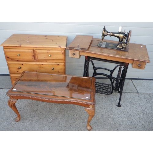 A treadle sewing machine, modern pine chest of drawers and a mahogany ...