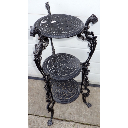 A cast iron three tier pan stand