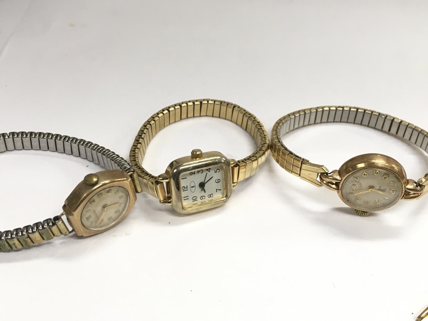 Six gold tone ladies watches.