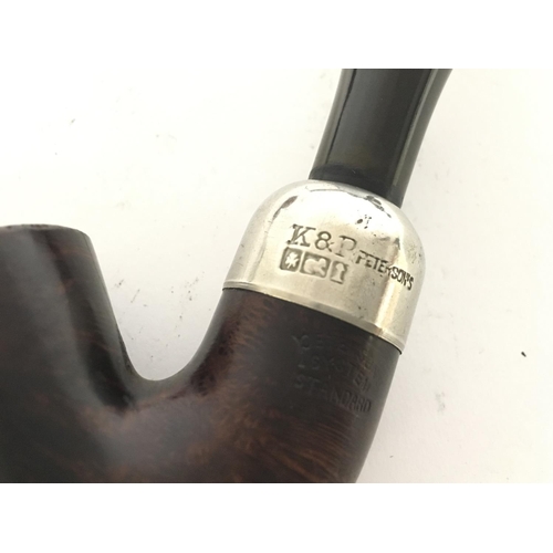 A collection of vintage smoking pipes including a Peterson silver ...