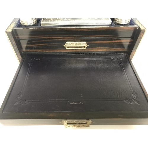 A Victorian Coromandel box fitted with an assortment of glass bottles ...