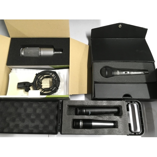 Four microphones comprising a boxed Audio Technica AT3035 example and ...