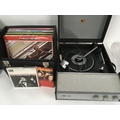 An HMV portable record player and a record case of LPs and 7" singles ...