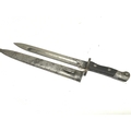 A German K98 German bayonet with wooden grip with unusual marks to the ...