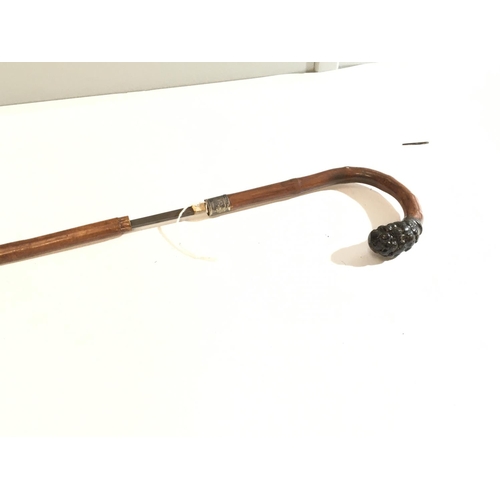 A British Wilkinson sword stick in a bamboo case with silver collar.