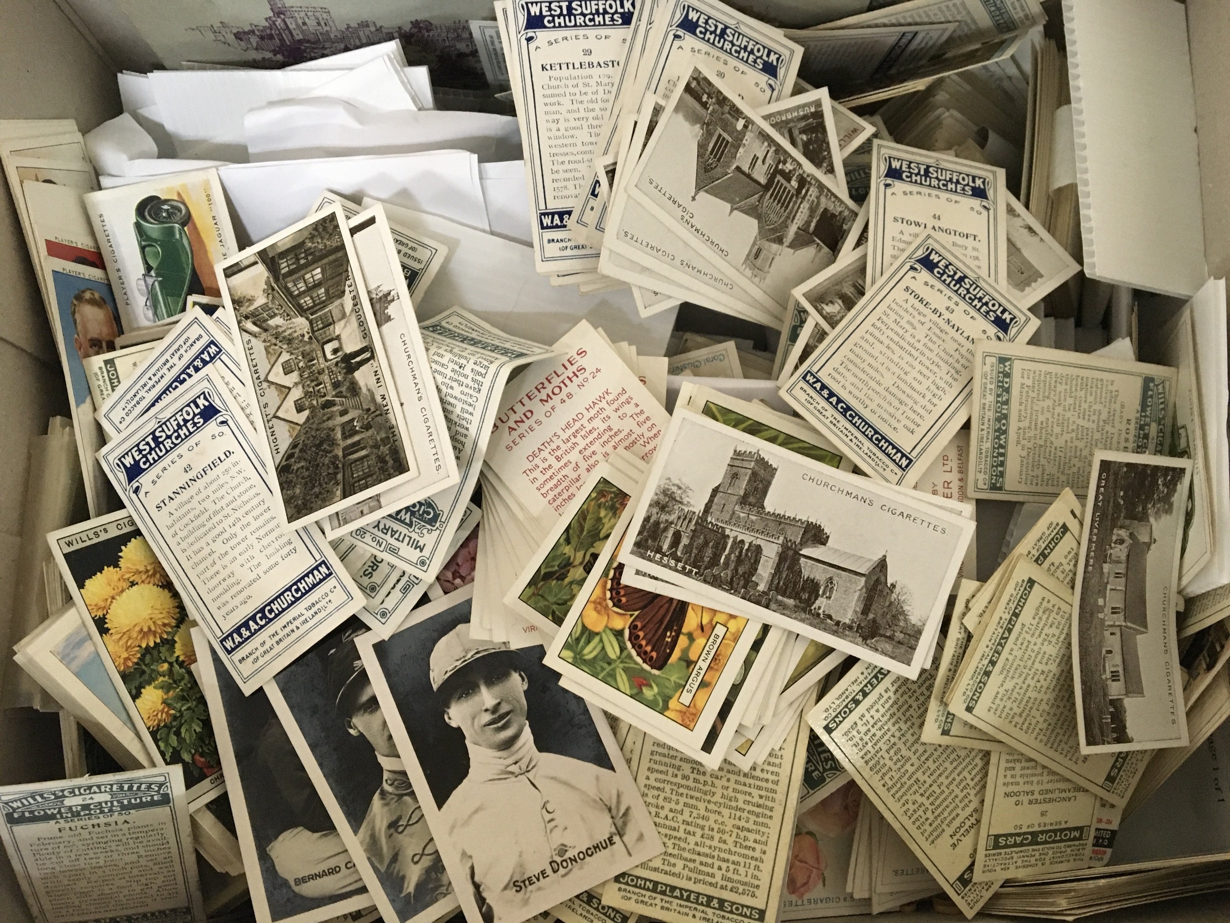 A box containing a large quantity of mixed loose cigarette cards.